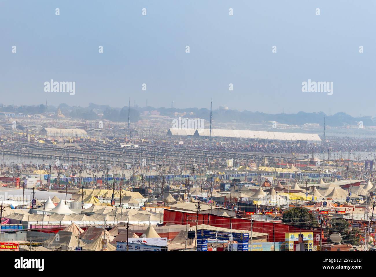 crowded temporary tent shelters with pontoon bridge over ganges river ...