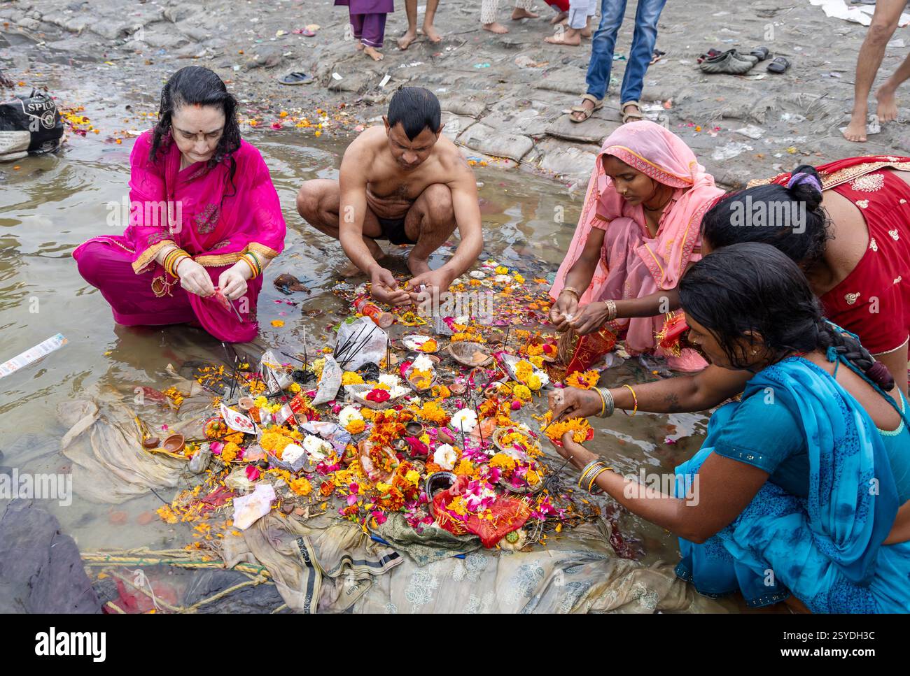 sacred devotees performing holy rituals at triveni sangam at mahakumbh ...