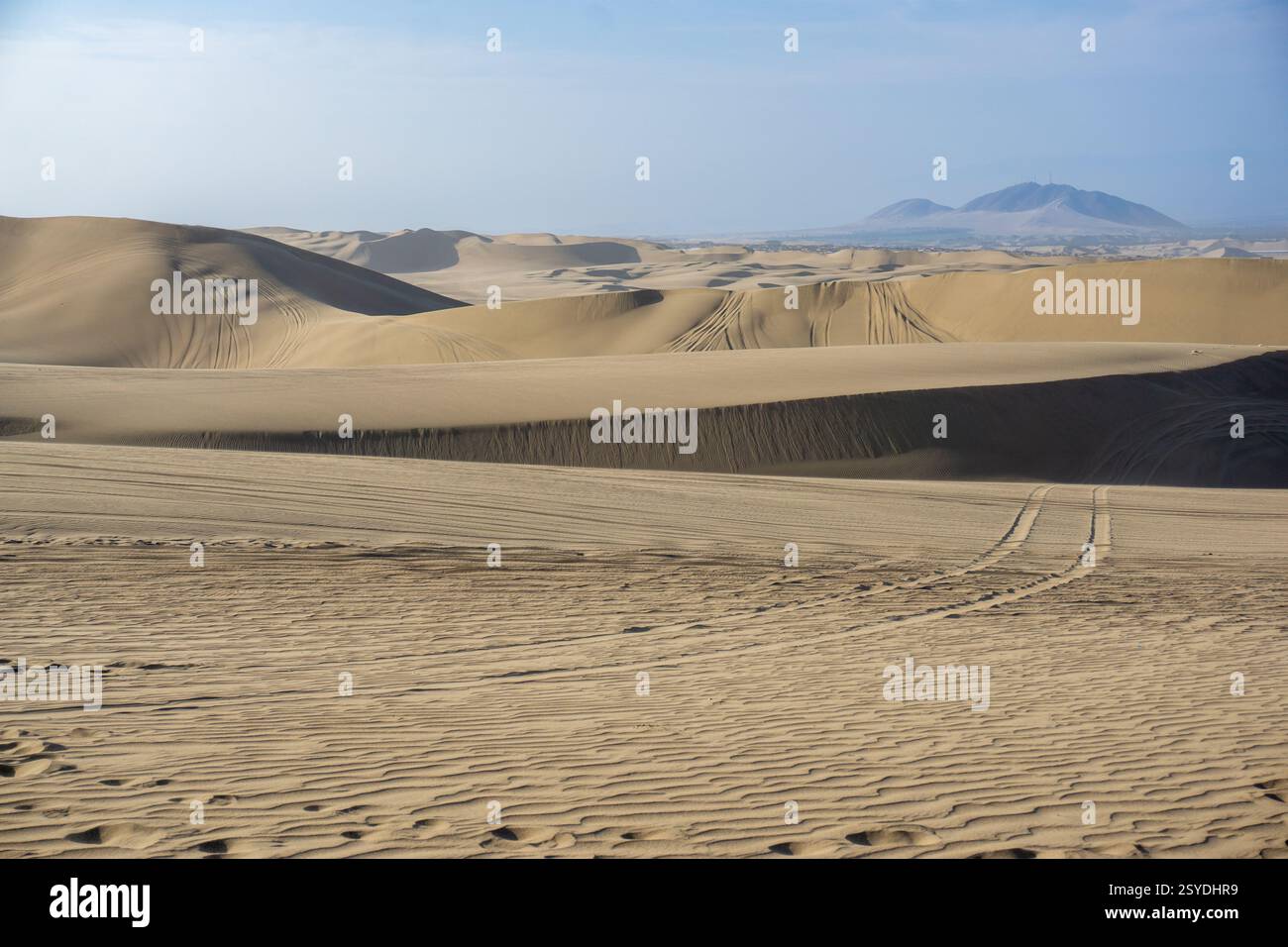 Huacachina Oasis in Peru surrounded by towering sand dunes and ...