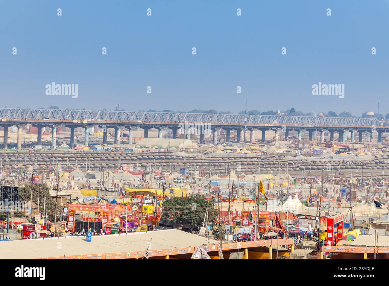 crowded temporary tent shelters with pontoon bridge over ganges river ...