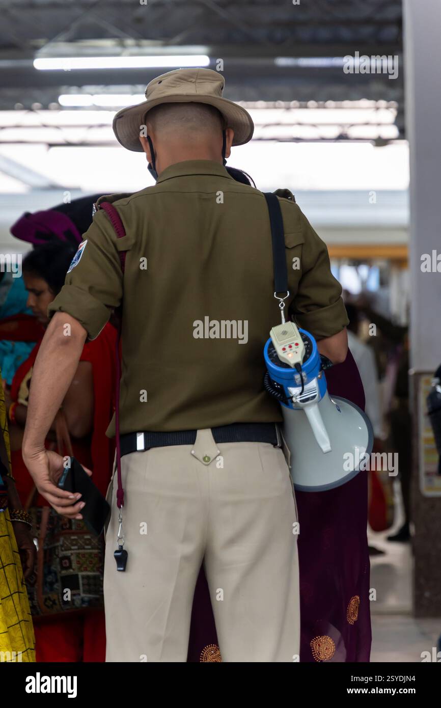 police man with loudhailer controlling crowd of mass gathering at ...