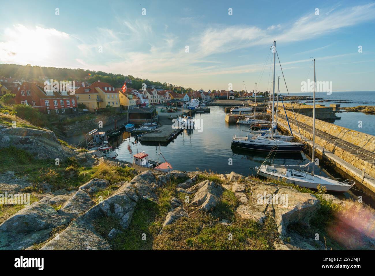 Waterfront village with colorful houses and docked boats, Gudhjem ...