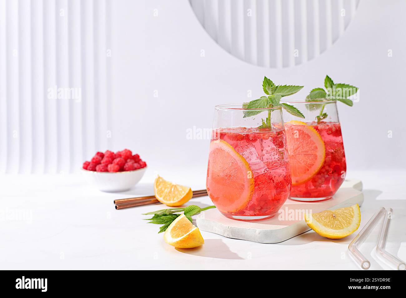 Refreshing summer homemade lemonade cocktail, mojito with raspberries, currants, mint and lemon ...