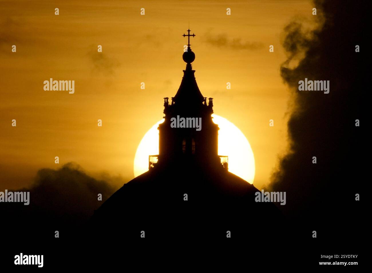The sun sets behind St. Peter's Basilica at the Vatican, Friday, Feb ...