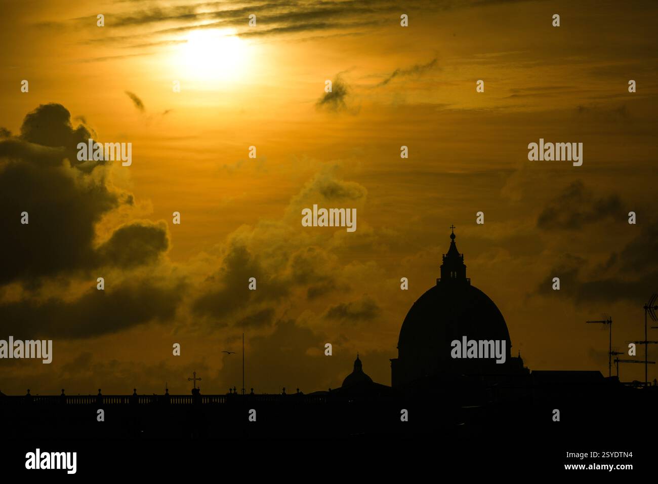 The sun sets behind St. Peter's Basilica at the Vatican, Friday, Feb ...