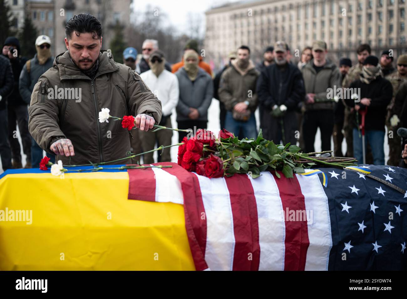 Non Exclusive: A man lays flowers on the coffin of Ethan Hertweck, a 21 ...