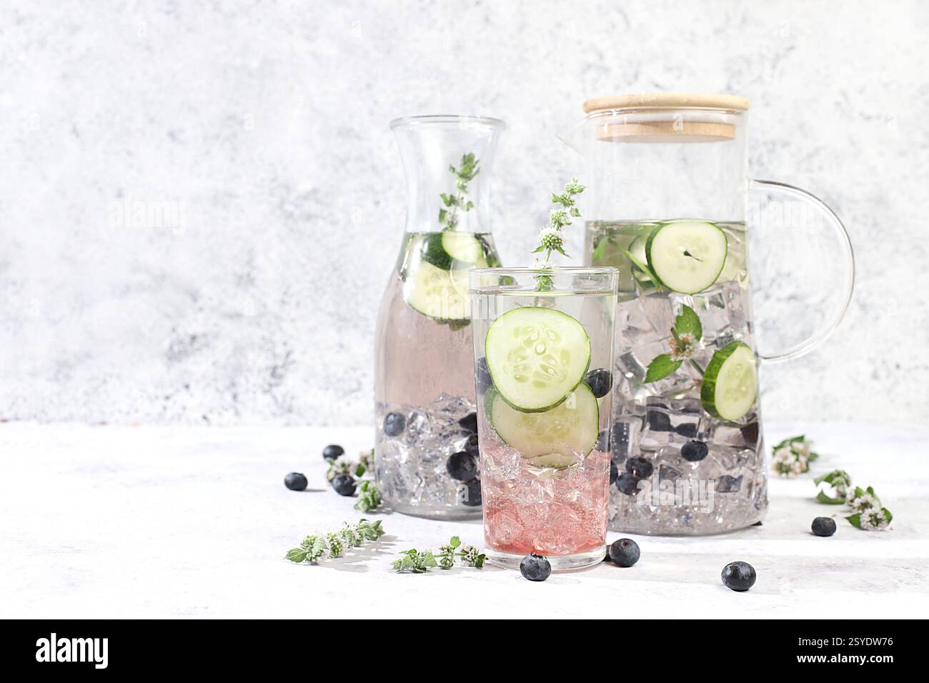 Detox fruit flavored water with cucumber and mint on a light background ...