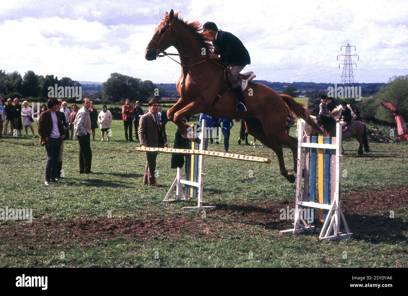 1970s, eventing, outside in a country field, a male rider on a horse ...