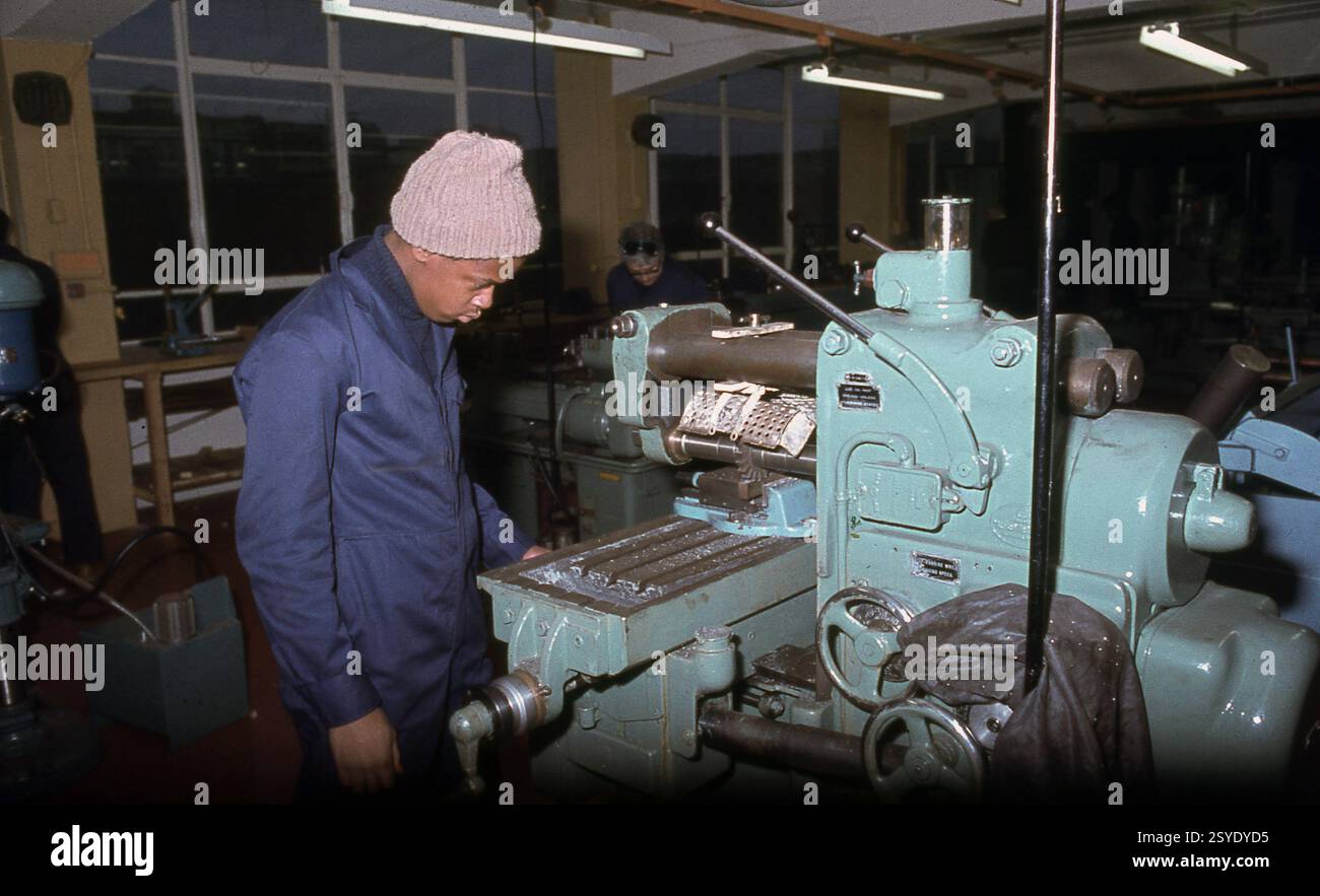 1977, a young caribbean male, a metal working apprentice, wearing blue ...