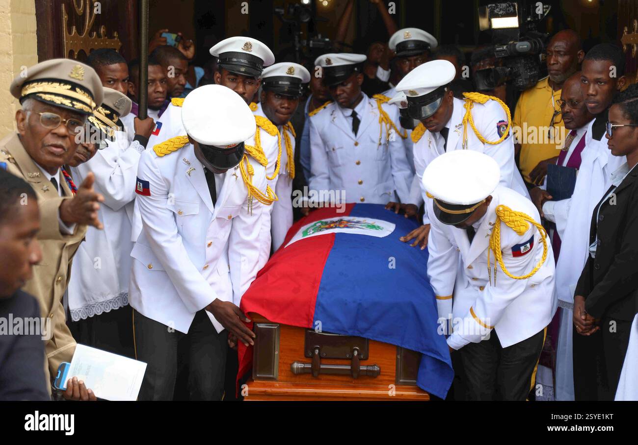 Members of the presidential guard push the coffin of Haitian writer ...