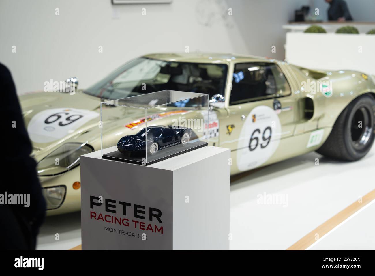 Classic racing car showcased at an exhibition with miniature replica in ...