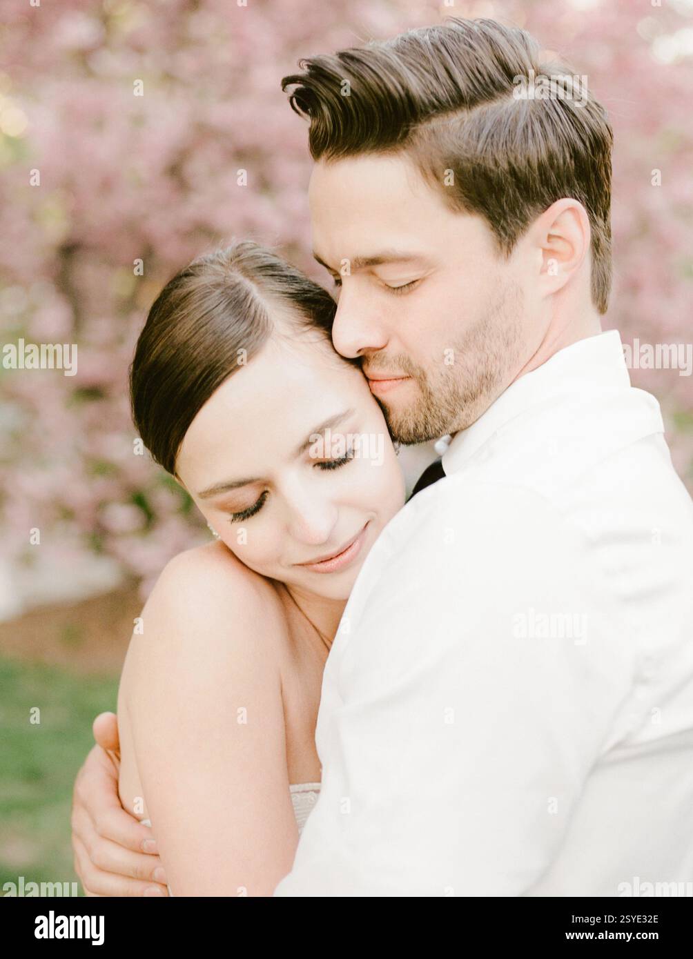 A couple shares a tender moment outdoors, enveloped in the beauty of ...