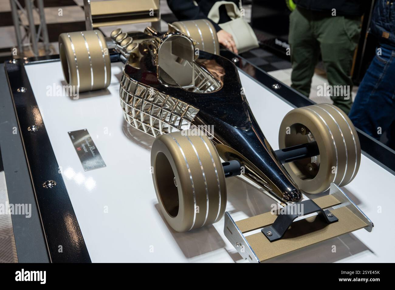 Unique golden racing car model on display at an automobile exhibition ...