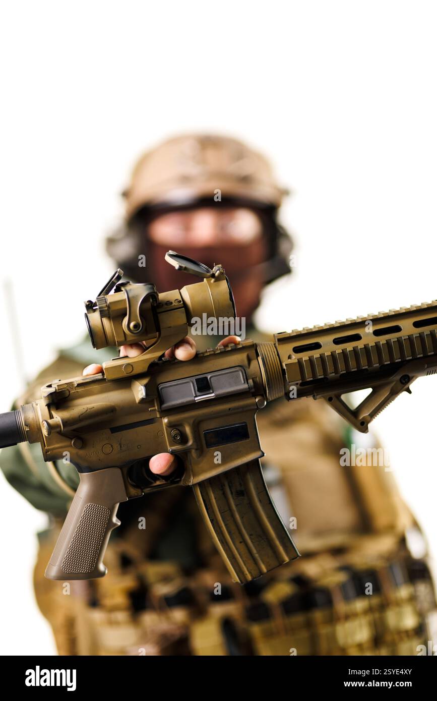 Detailed view of a tactical assault rifle held by a soldier clad in ...