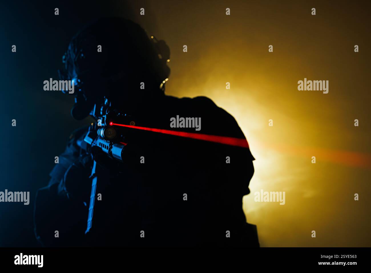 Silhouette of a soldier aiming a weapon with a laser sight under ...