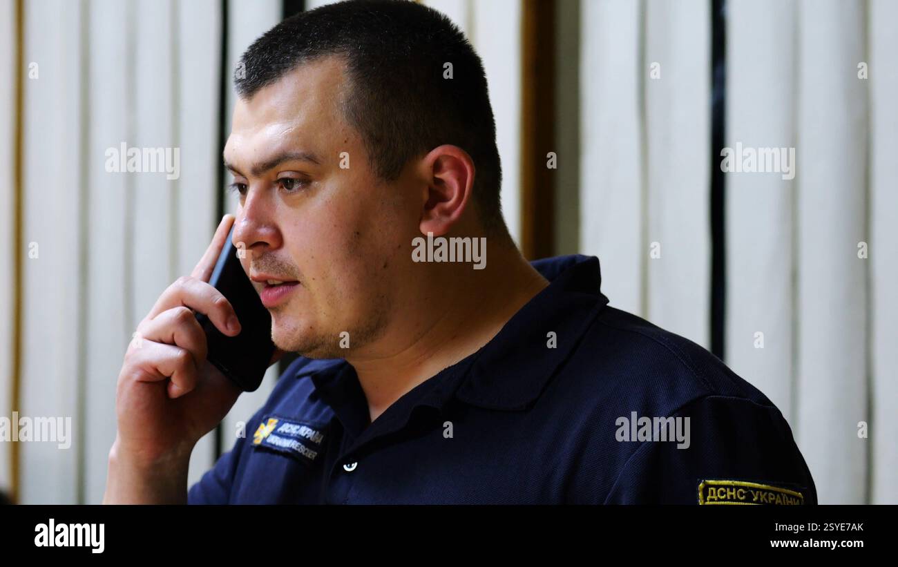Male firefighter chief have serious telephone conversation with his ...