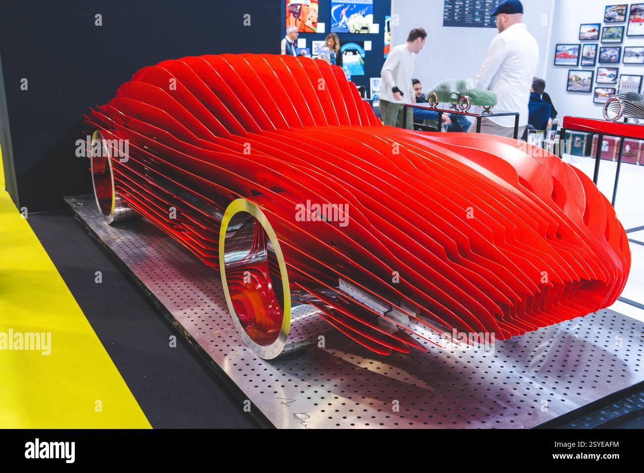 Intricate red sculpture captures the essence of a classic sports car ...