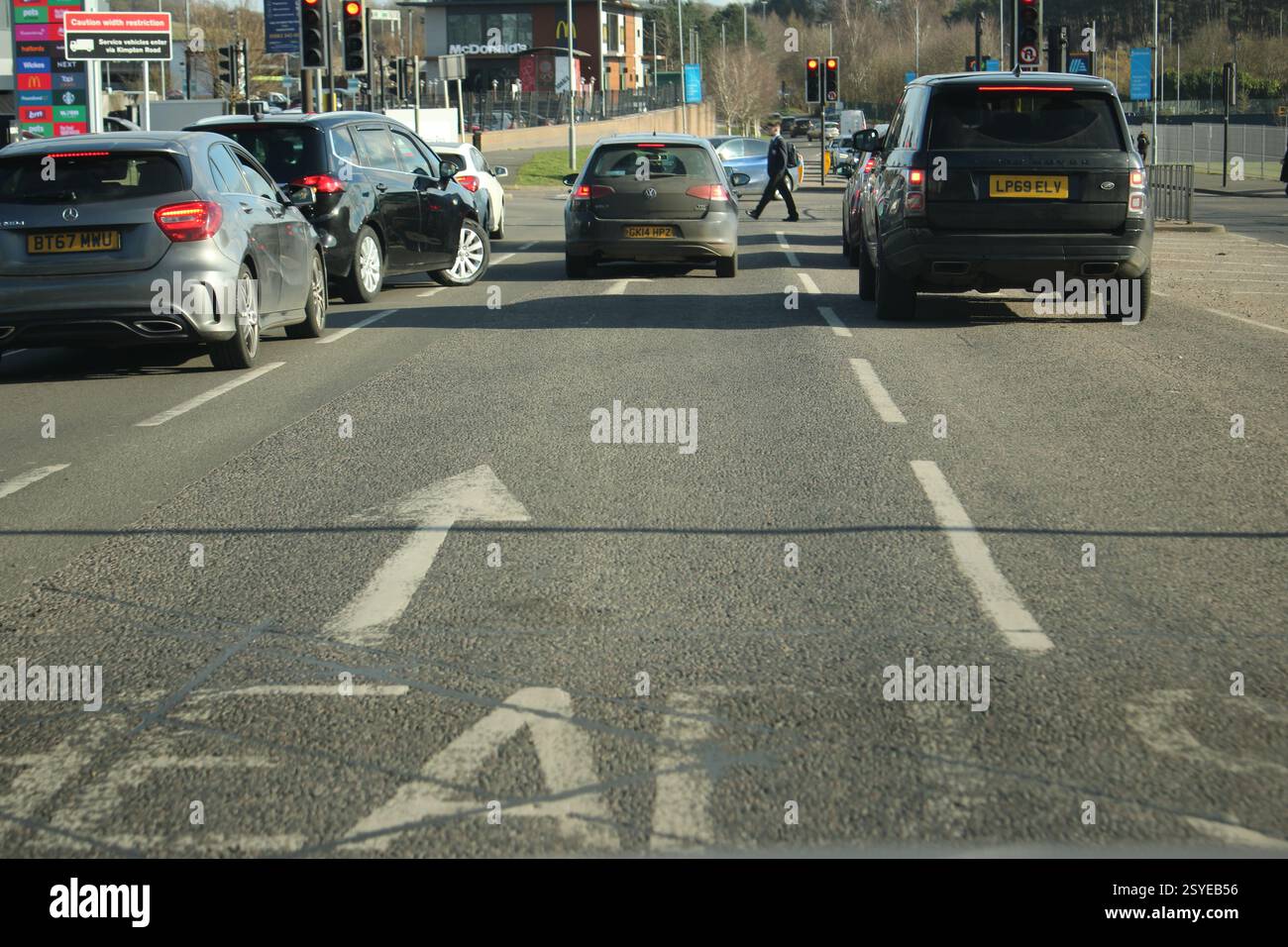 Three lanes of traffic queuing at a set of traffic lights Luton ...