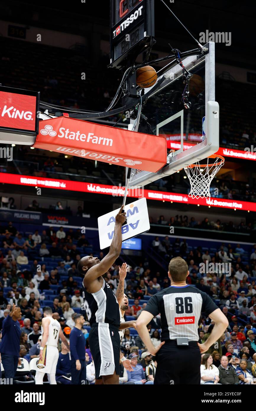 San Antonio Spurs center Bismack Biyombo (18) uses a mop to remove a ...