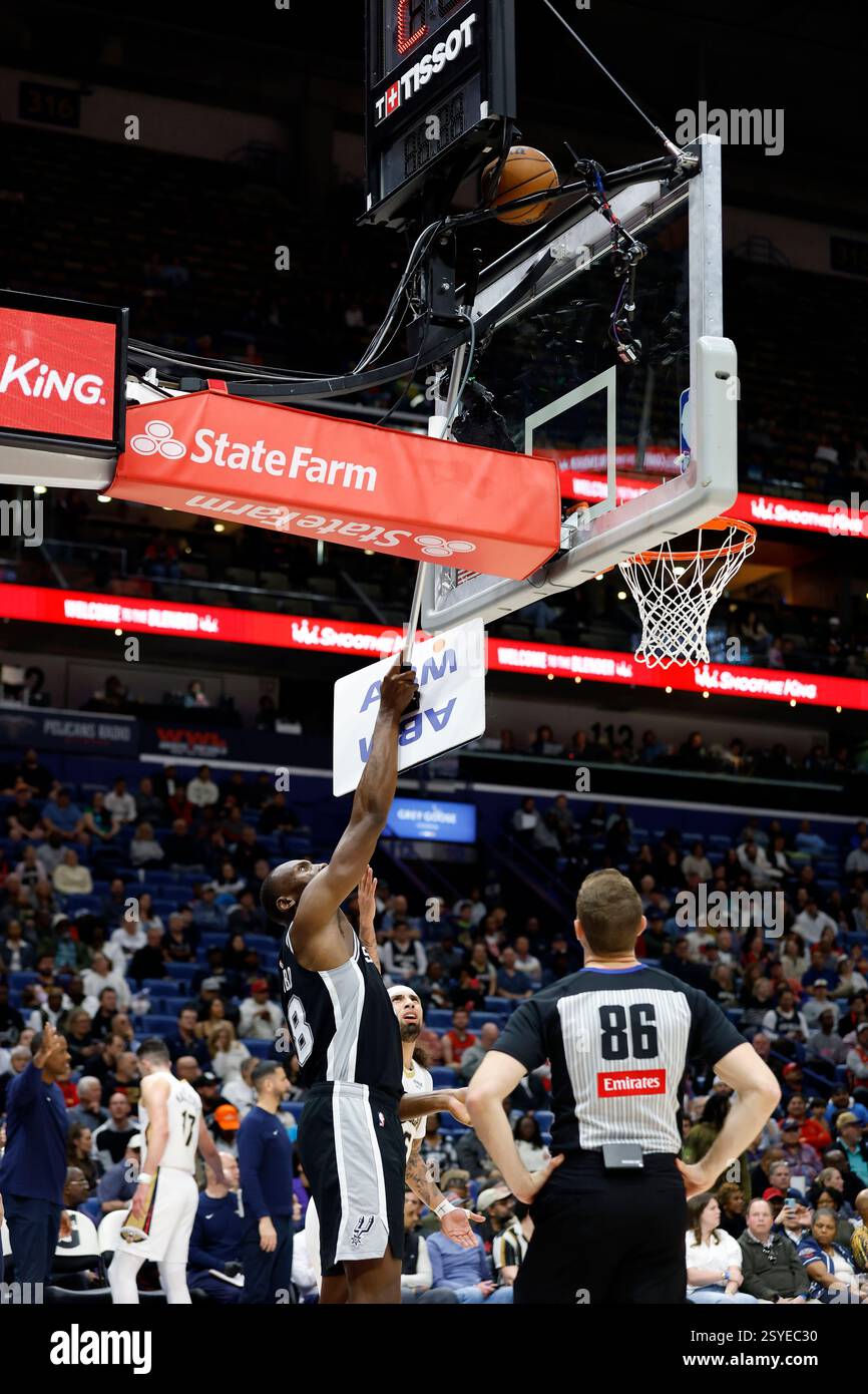 San Antonio Spurs center Bismack Biyombo (18) uses a mop to remove a ...