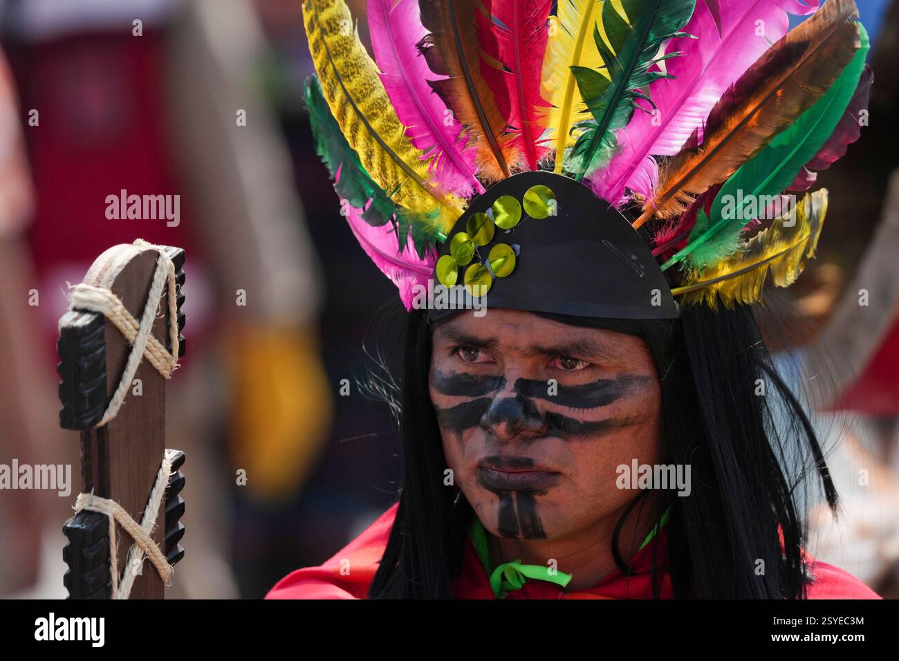 A man in Indigenous costume attends a state funeral ceremony ...