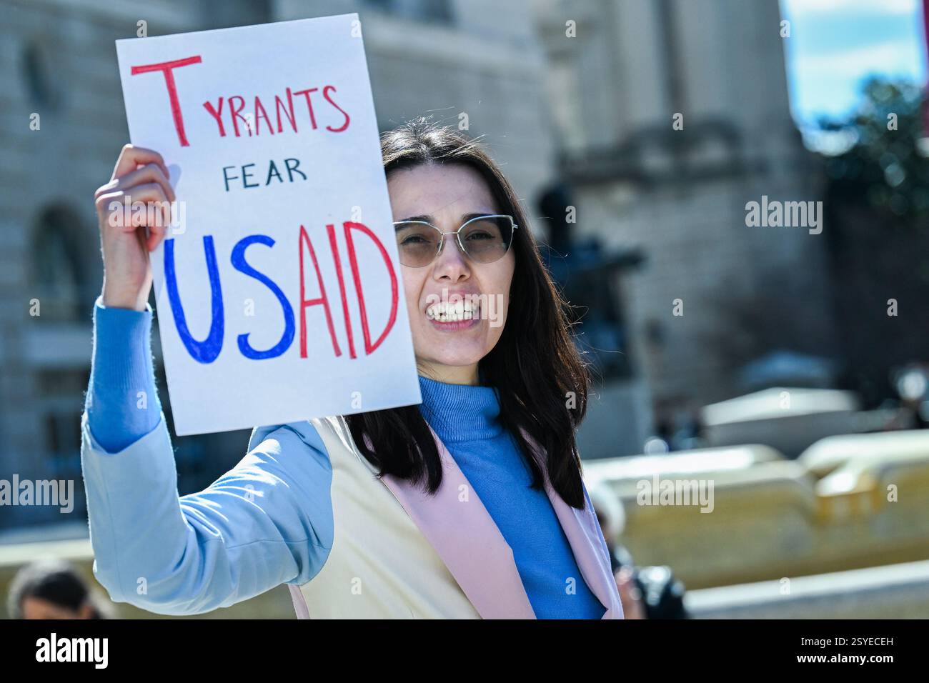 Laid-off staff exit the USAID offices as people rally in support in ...