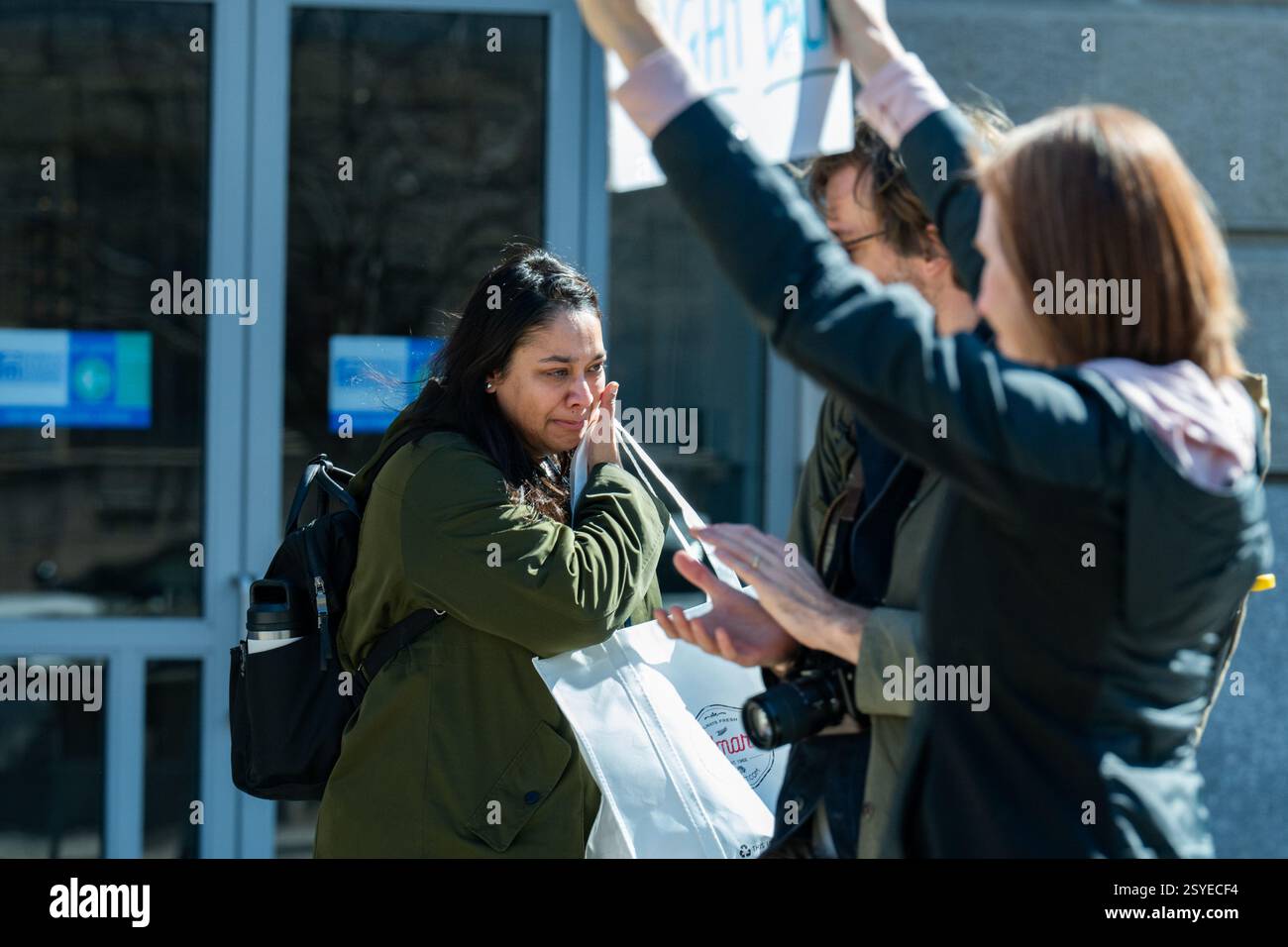 Laid-off staff exit the USAID offices as people rally in support in ...