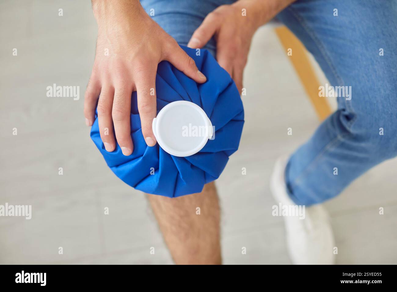 Close up of man hand holding ice pack bag applying cold compress to leg ...