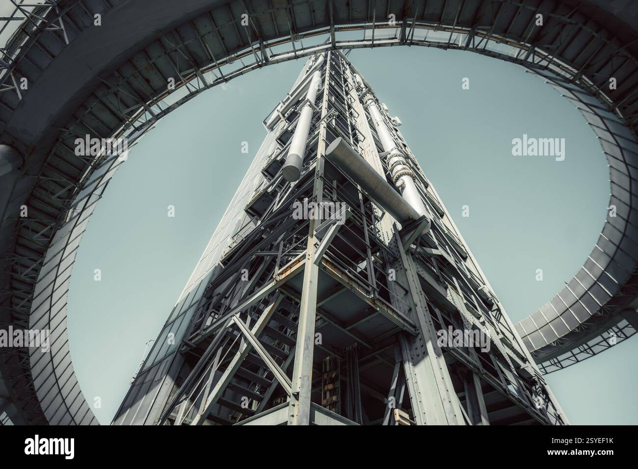 Low-angle view of a towering industrial metal structure with intricate ...