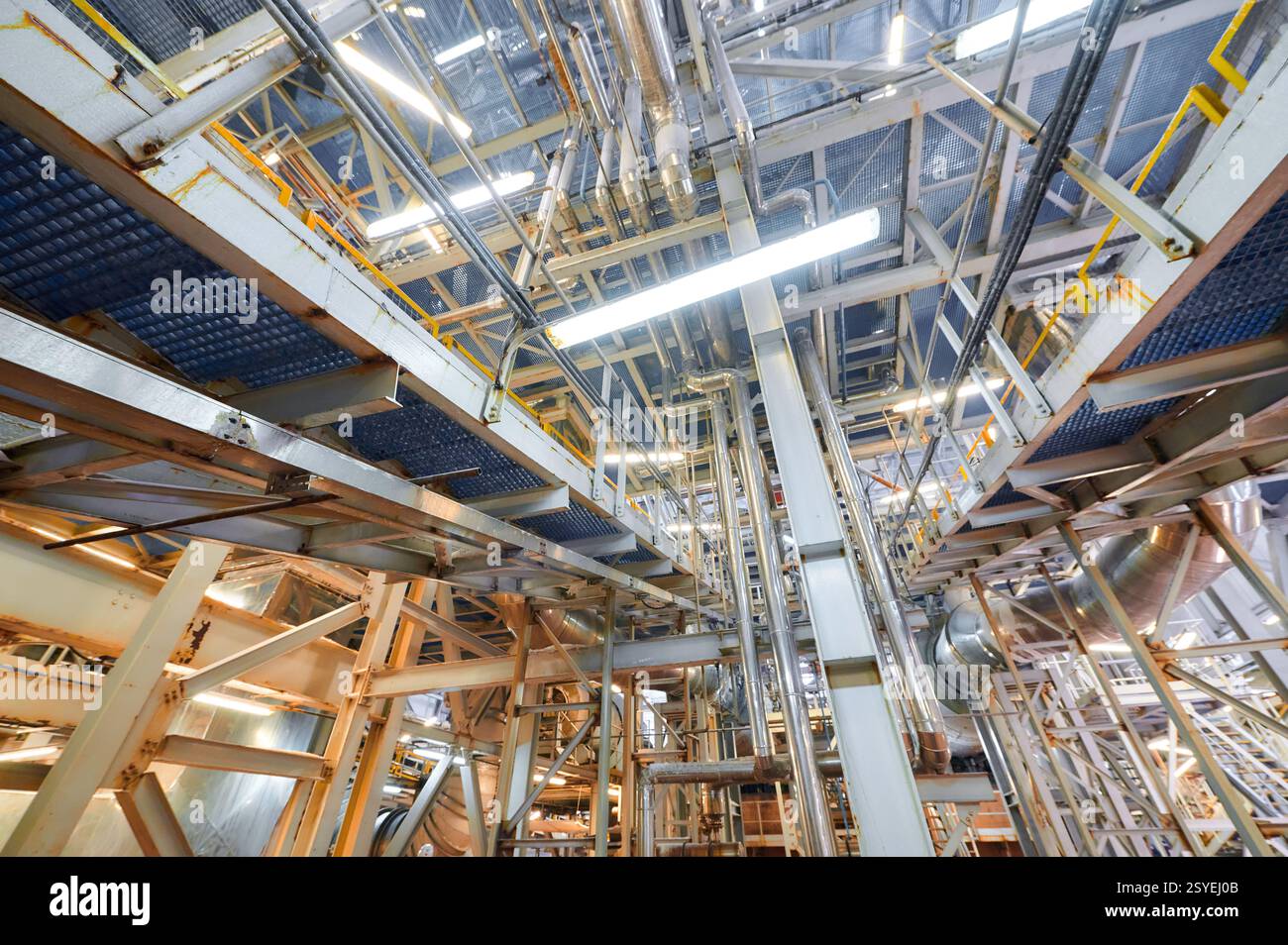 Inside a chemical plant showcasing extensive pipelines and conveyor ...