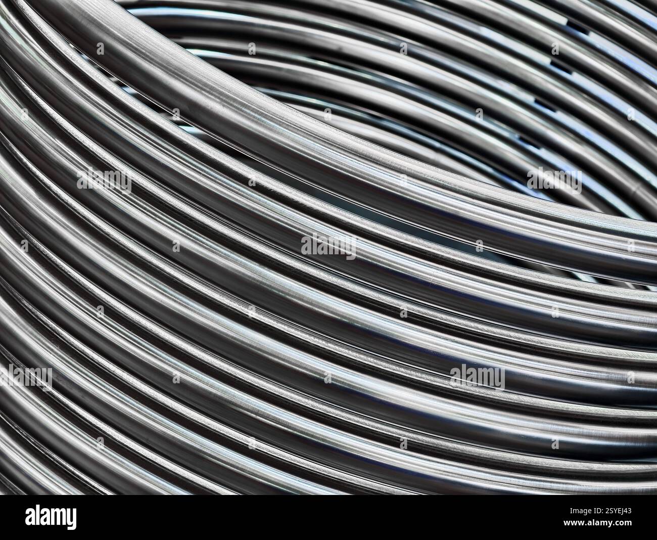 Metallic coils shine under soft light in an artistic display of ...
