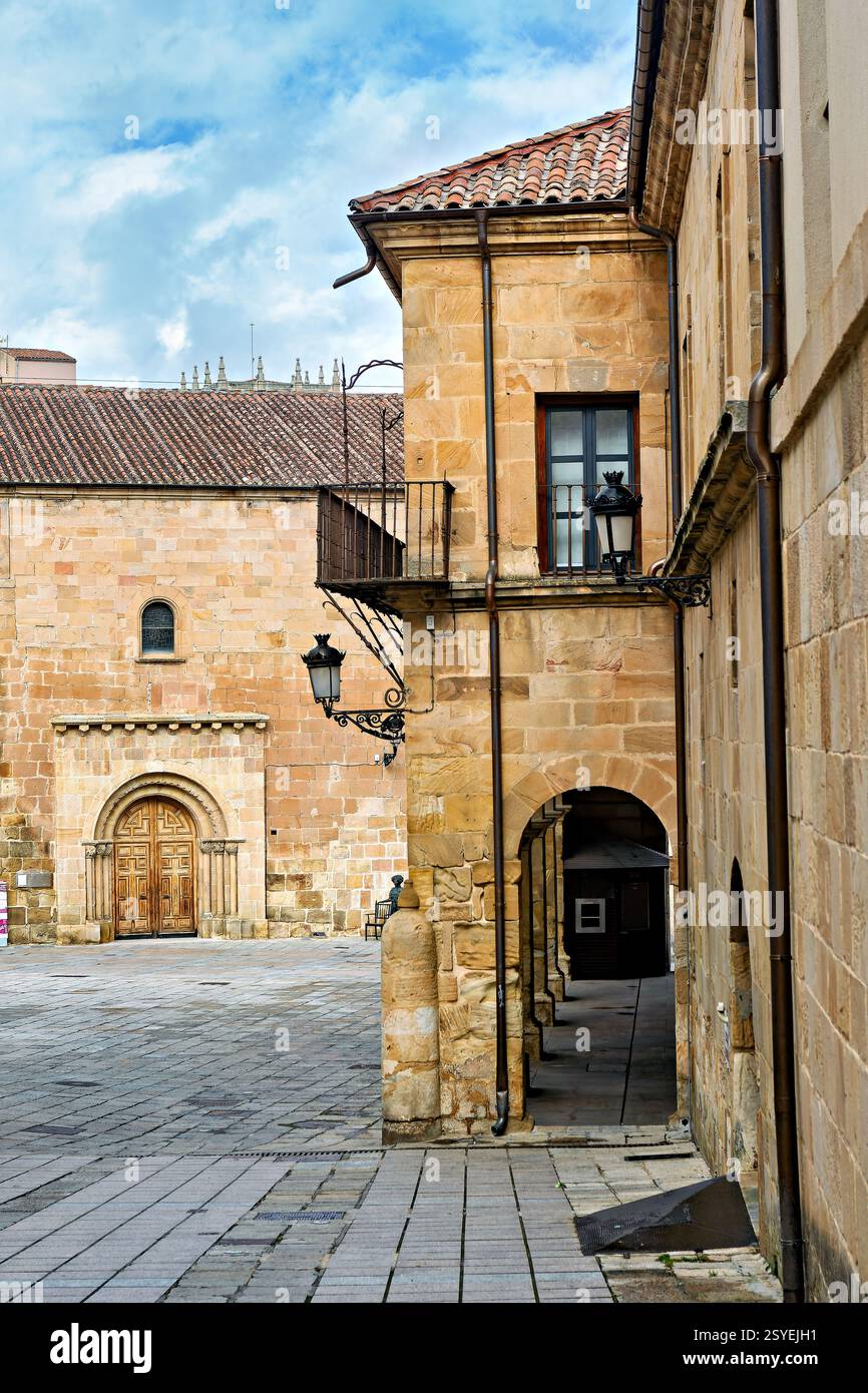 Ancient stone church with Romanesque features, arched doorway, and ...