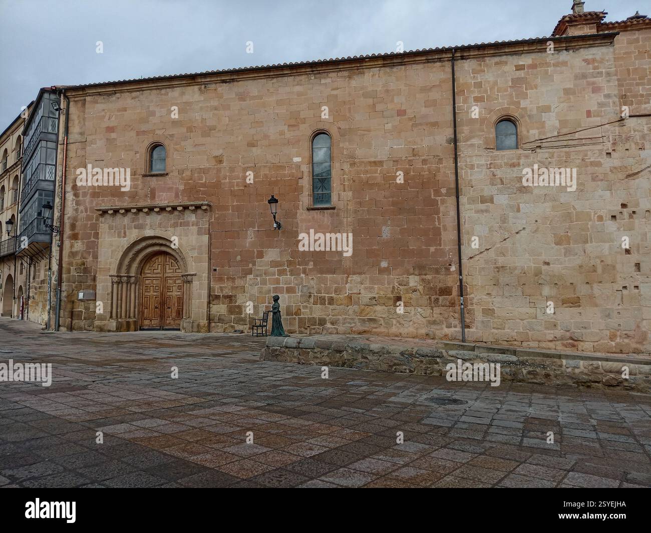 Ancient stone church with Romanesque features, arched doorway, and ...