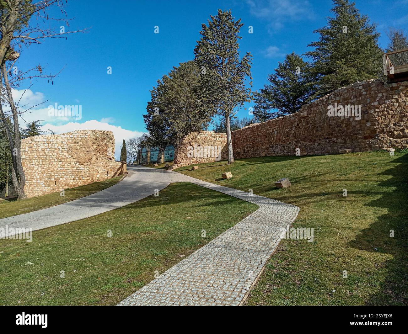 Medieval stone wall ruins in Soria, Spain, surrounded by greenery and ...