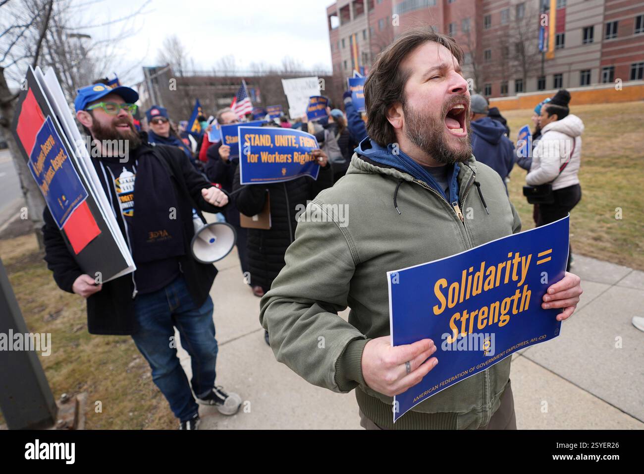Protesters walk outside the John D. Dingell Veterans Affairs Medical ...