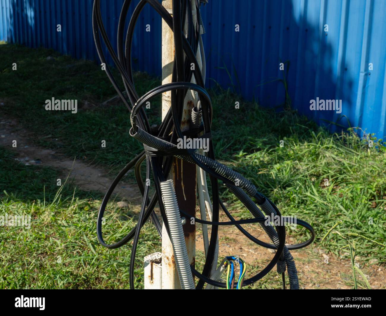 Exposed wiring in a metal pole. Wires sticking out. Pole with wires ...
