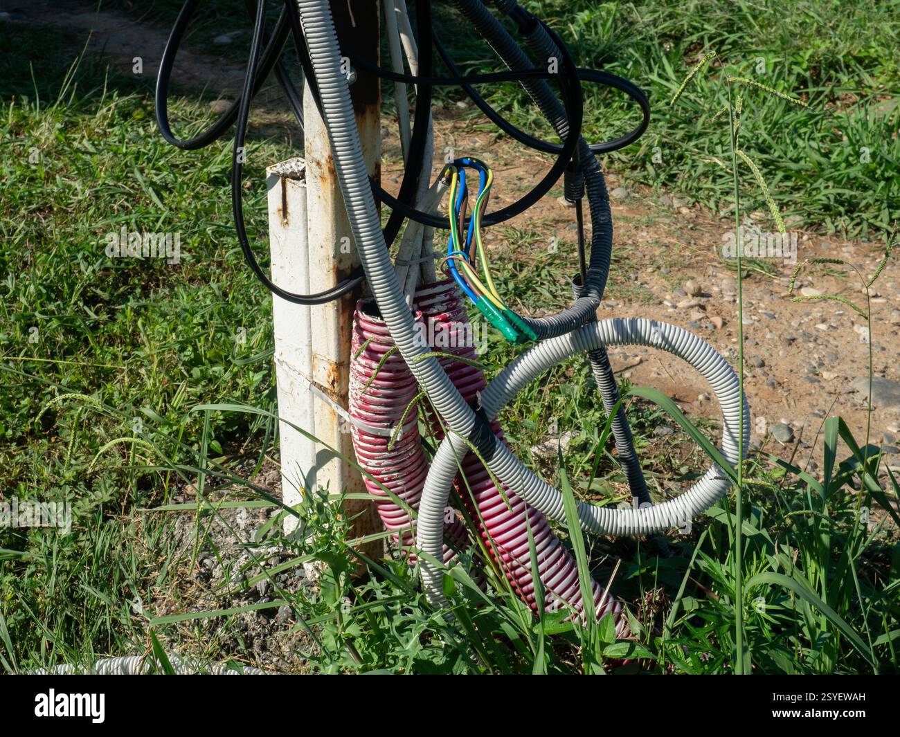 Exposed wiring in a metal pole. Wires sticking out. Pole with wires ...