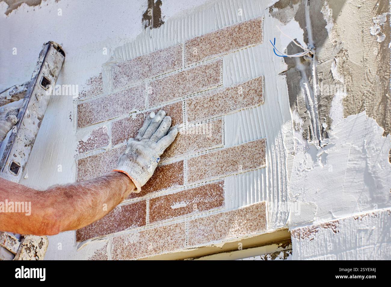 DIY Facade Finish With Imitation Brick, homeowner adding panel with ...