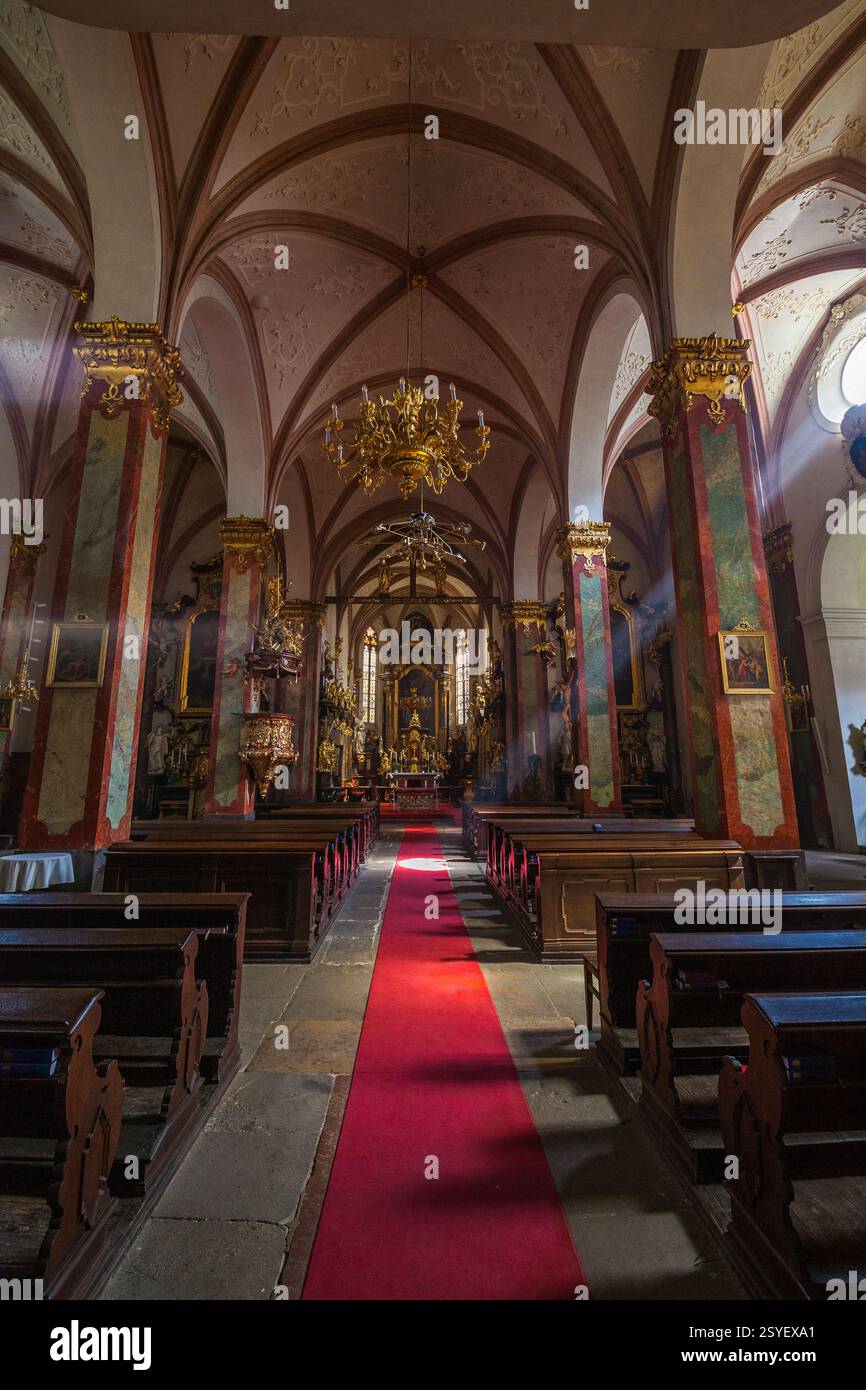 Interior view of a grand church featuring a long nave with arched ...