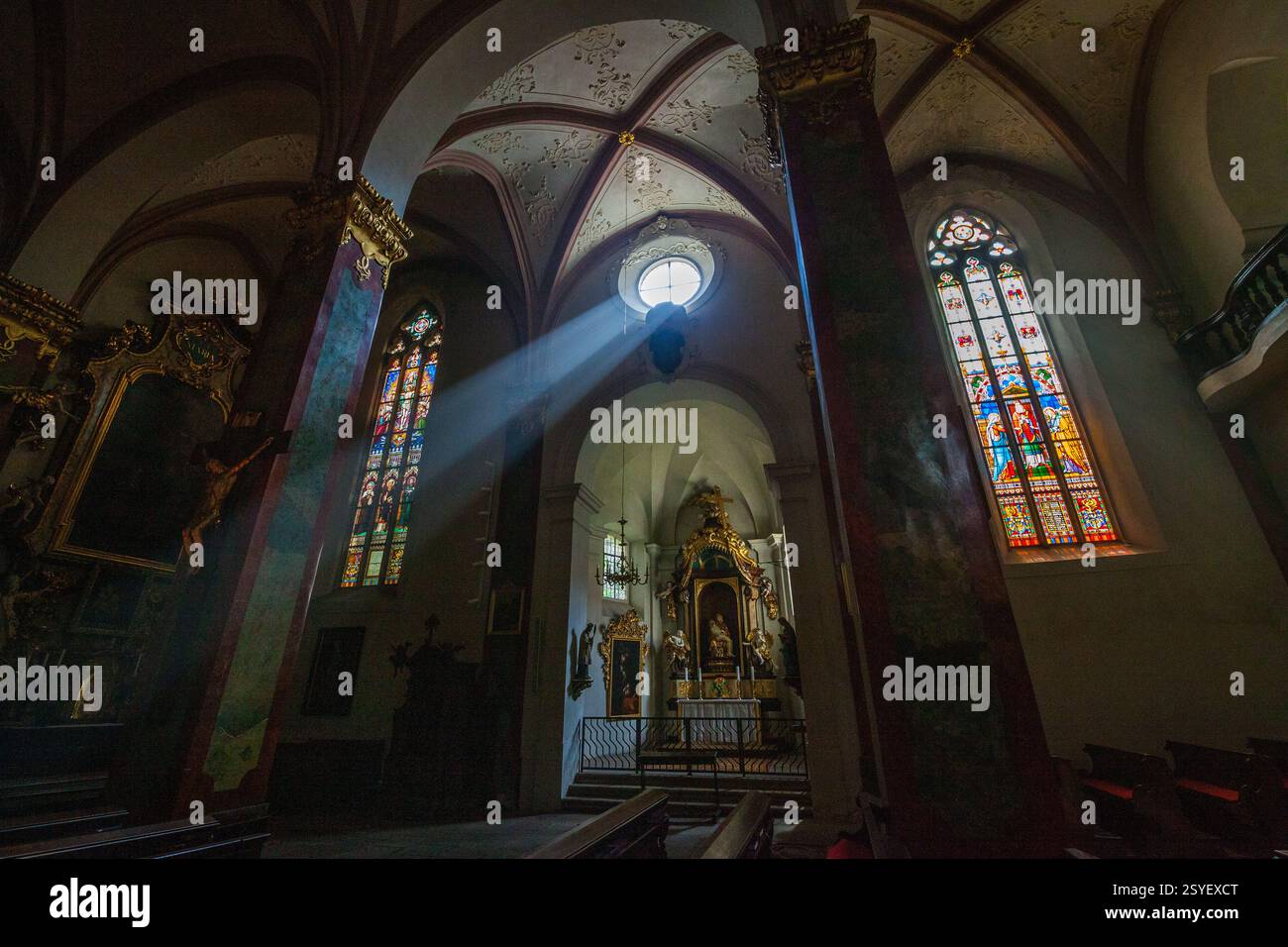 Interior view of a church featuring a striking beam of light piercing ...