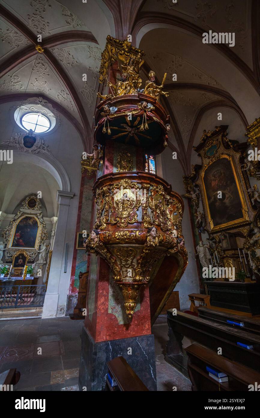 A richly decorated pulpit, featuring ornate carvings and gilded details ...