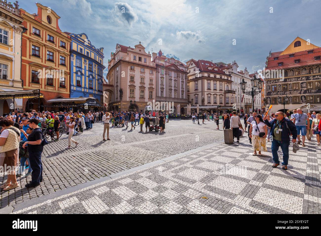 A wide cobblestone square in a European city featuring a historic ...