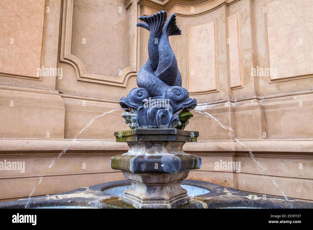 A decorative fountain featuring two intertwined fish or dolphin figures ...