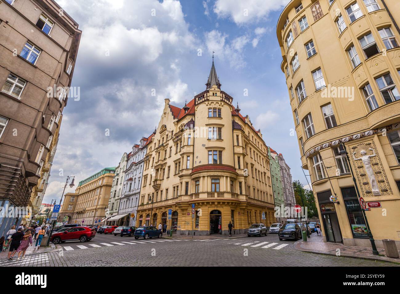 A low-angle view of a European city street featuring a unique corner ...