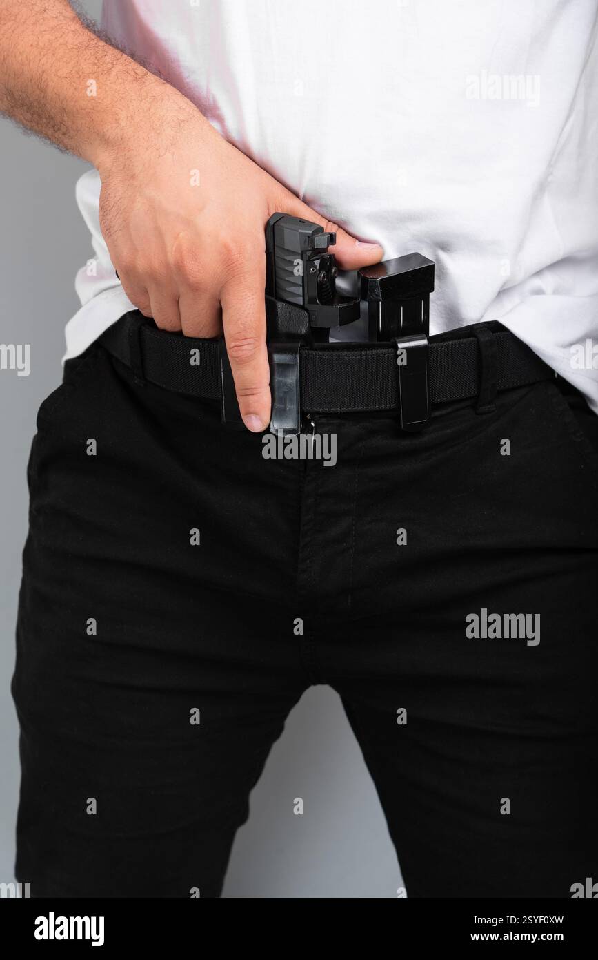 Shooting instructor wearing white shirt and black pants holding ...