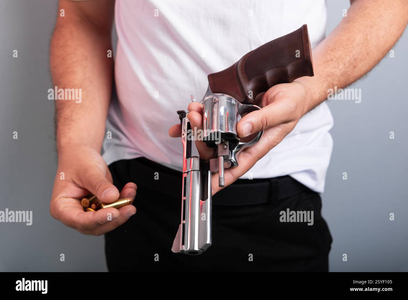 Detail of the hands of a shooting instructor holding a pistol in one ...