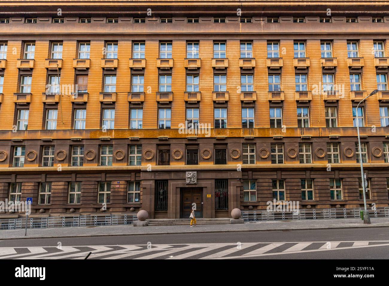 A large, symmetrical building with a textured facade featuring rows of ...