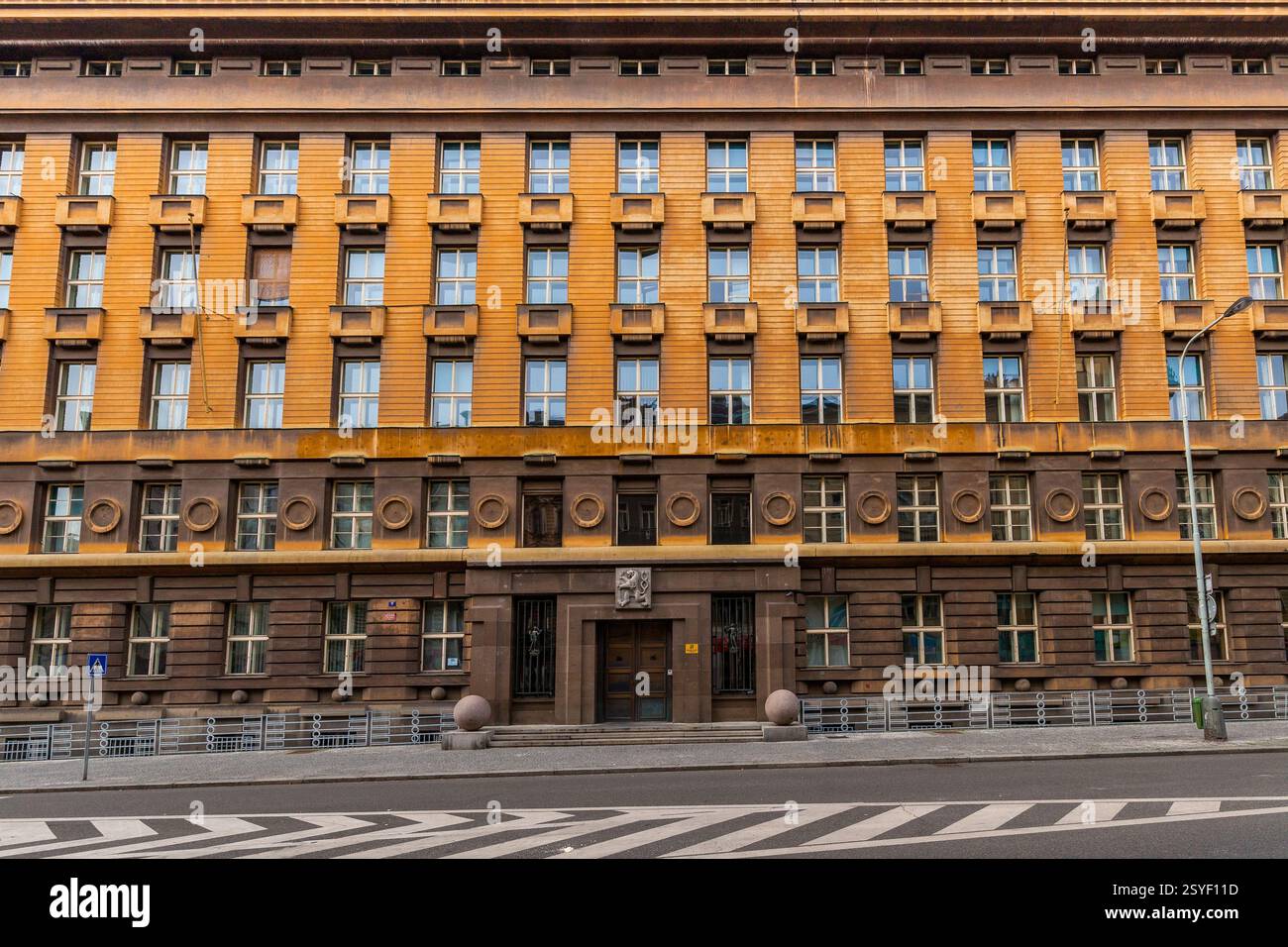 A large, symmetrical building with a textured facade featuring rows of ...