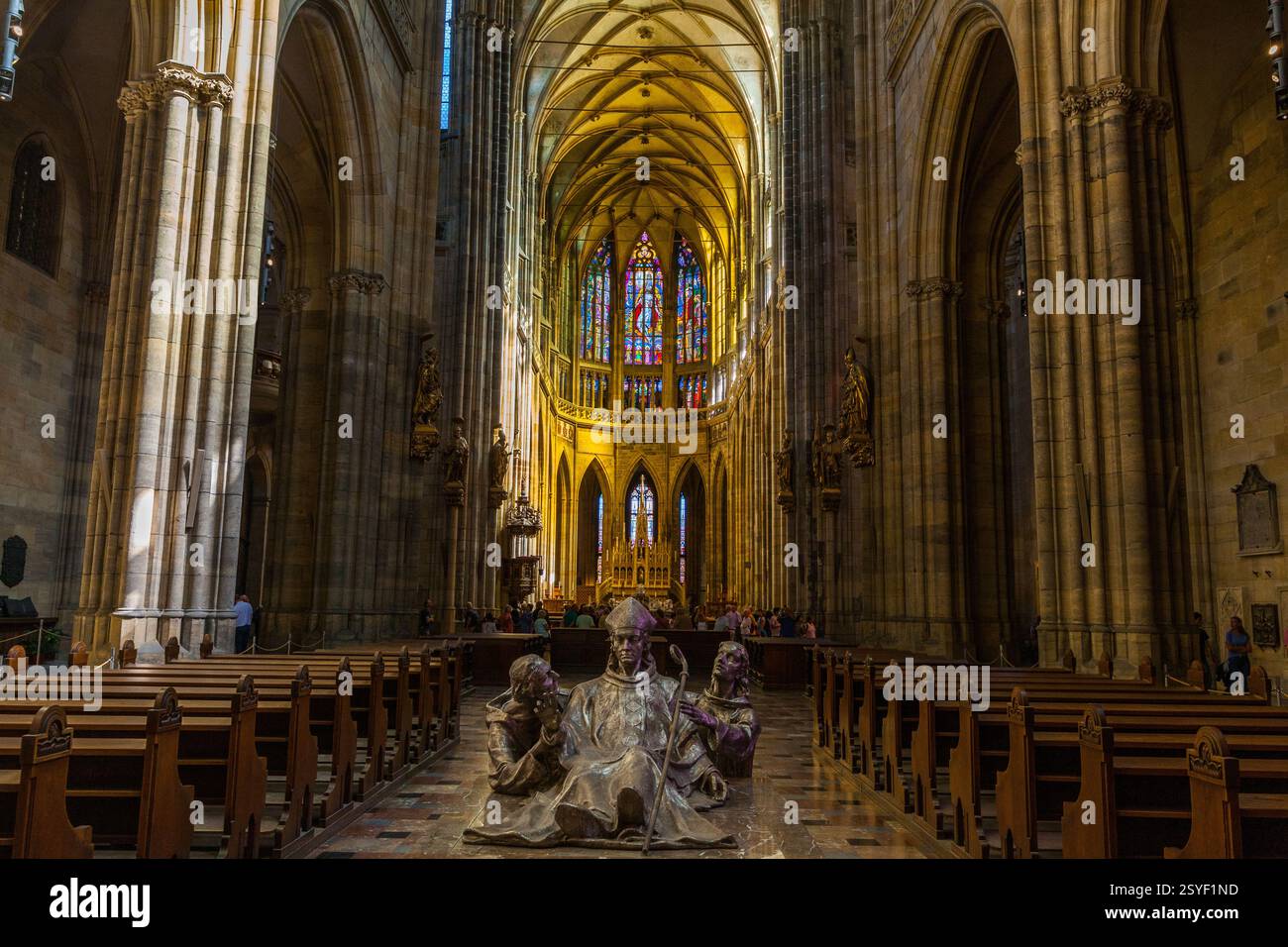 The image depicts the expansive interior of a gothic cathedral ...
