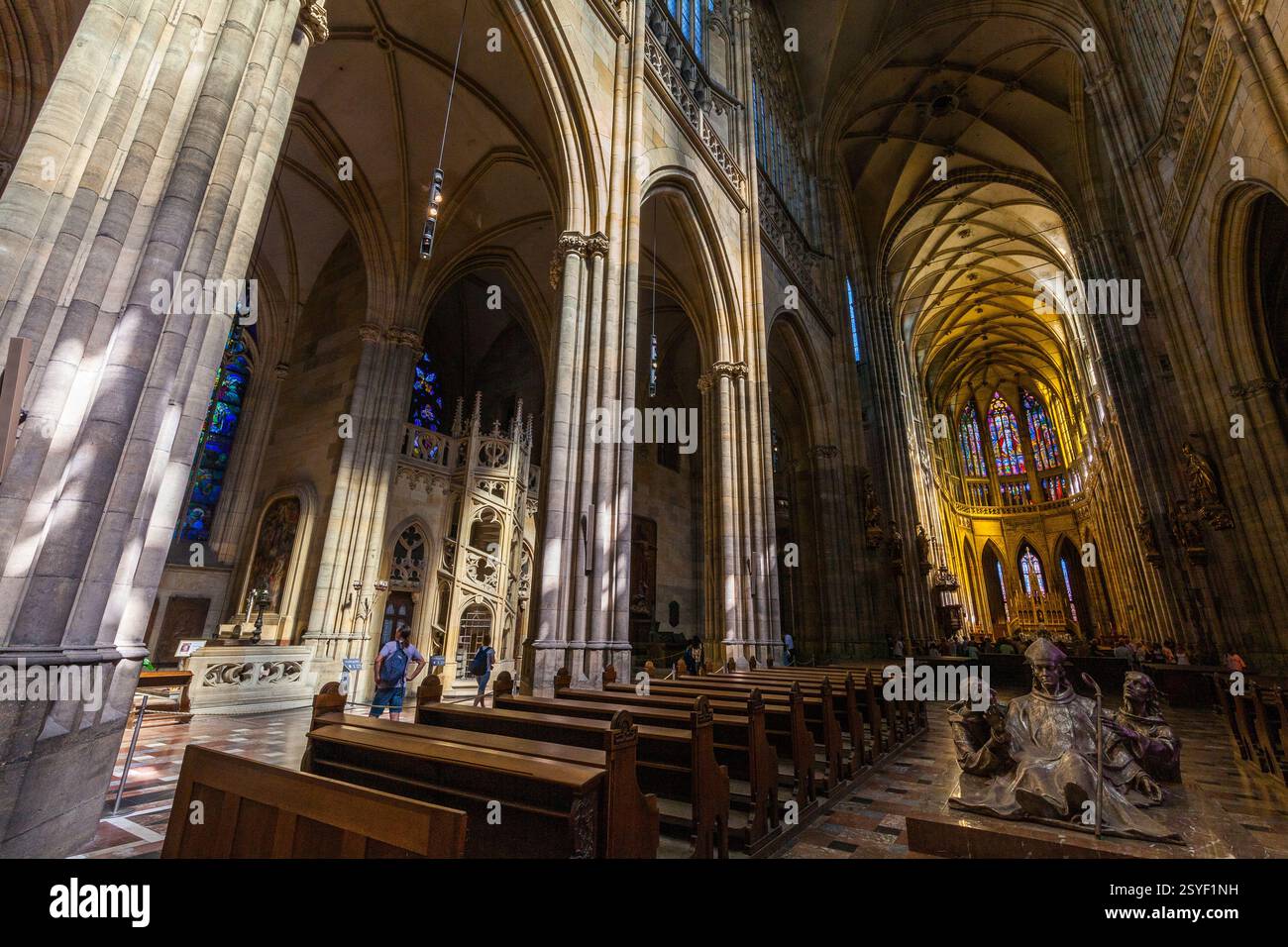 The image depicts the expansive interior of a gothic cathedral ...